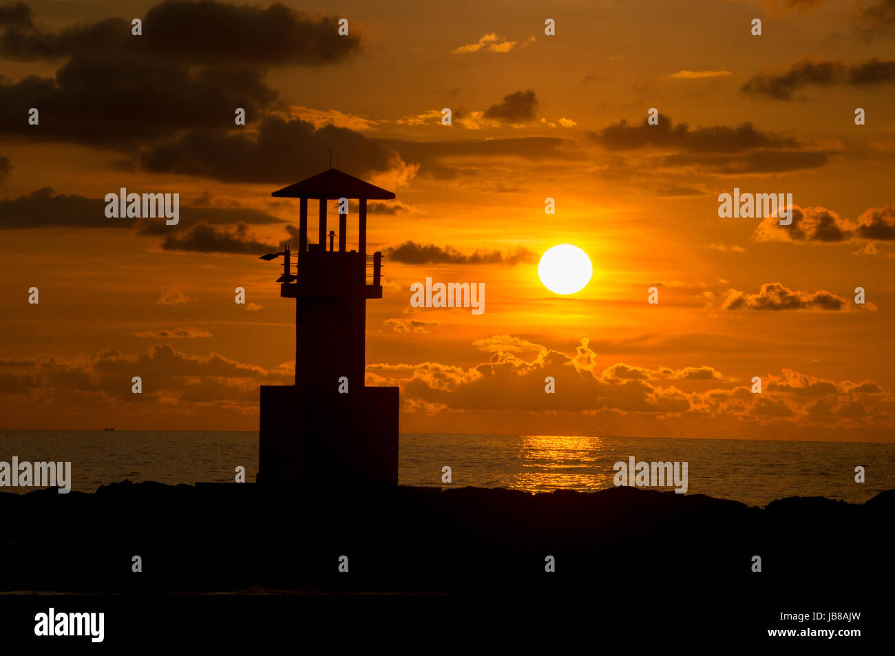 Lighthouse at sunset Stock Photo - Alamy