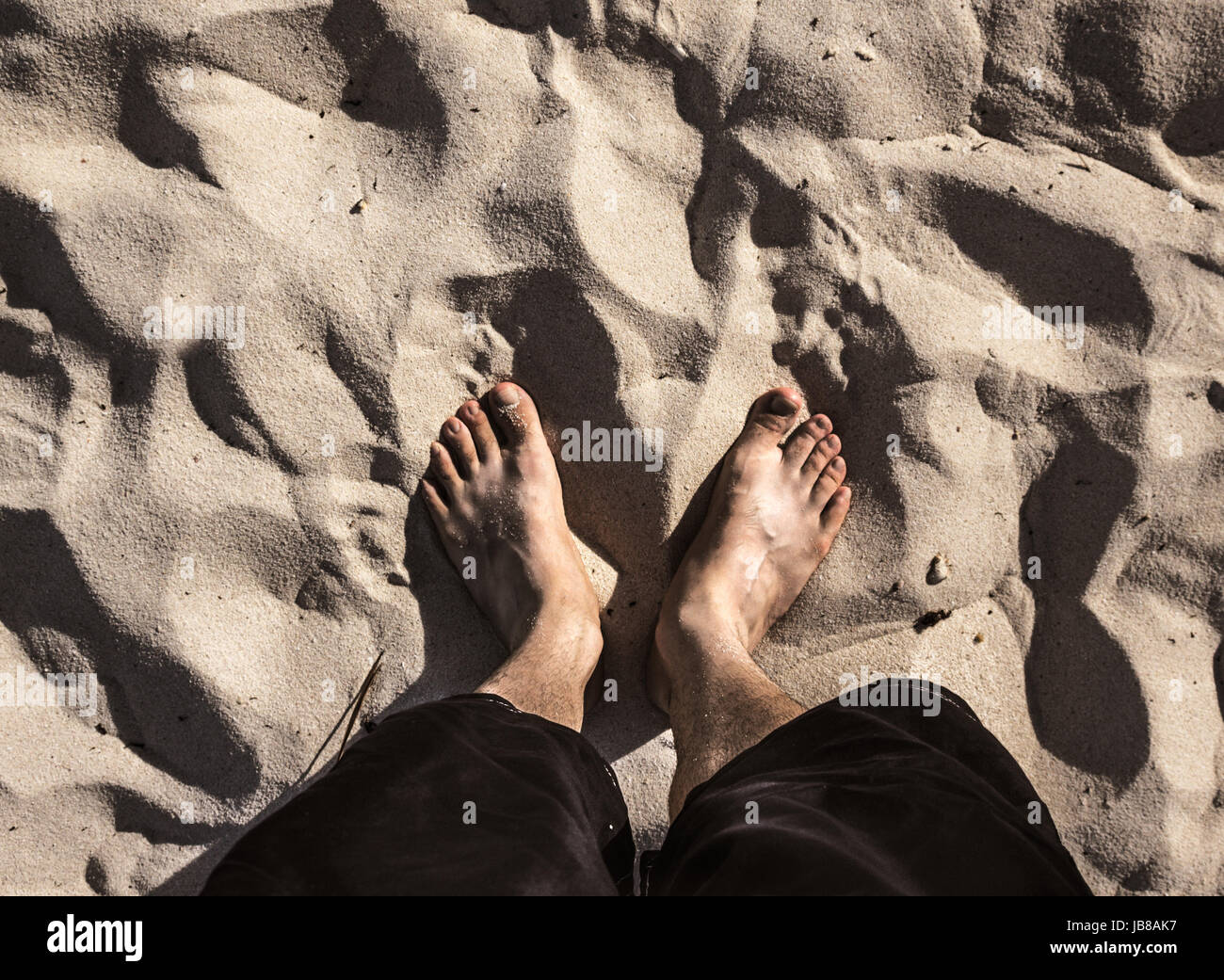 Photograph of a pair of feet on beach sand Stock Photo - Alamy