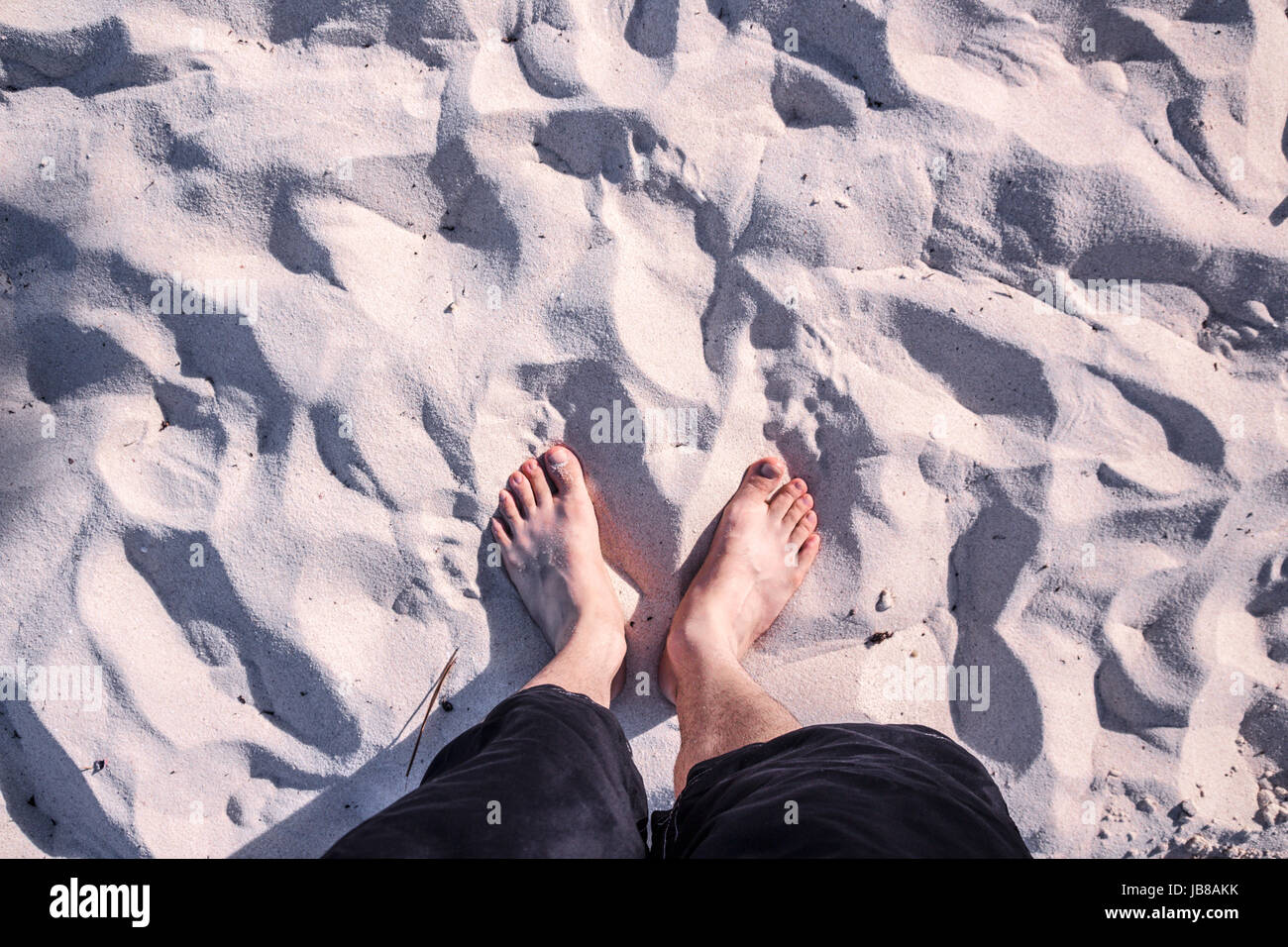 Photograph of a pair of feet on beach sand Stock Photo - Alamy