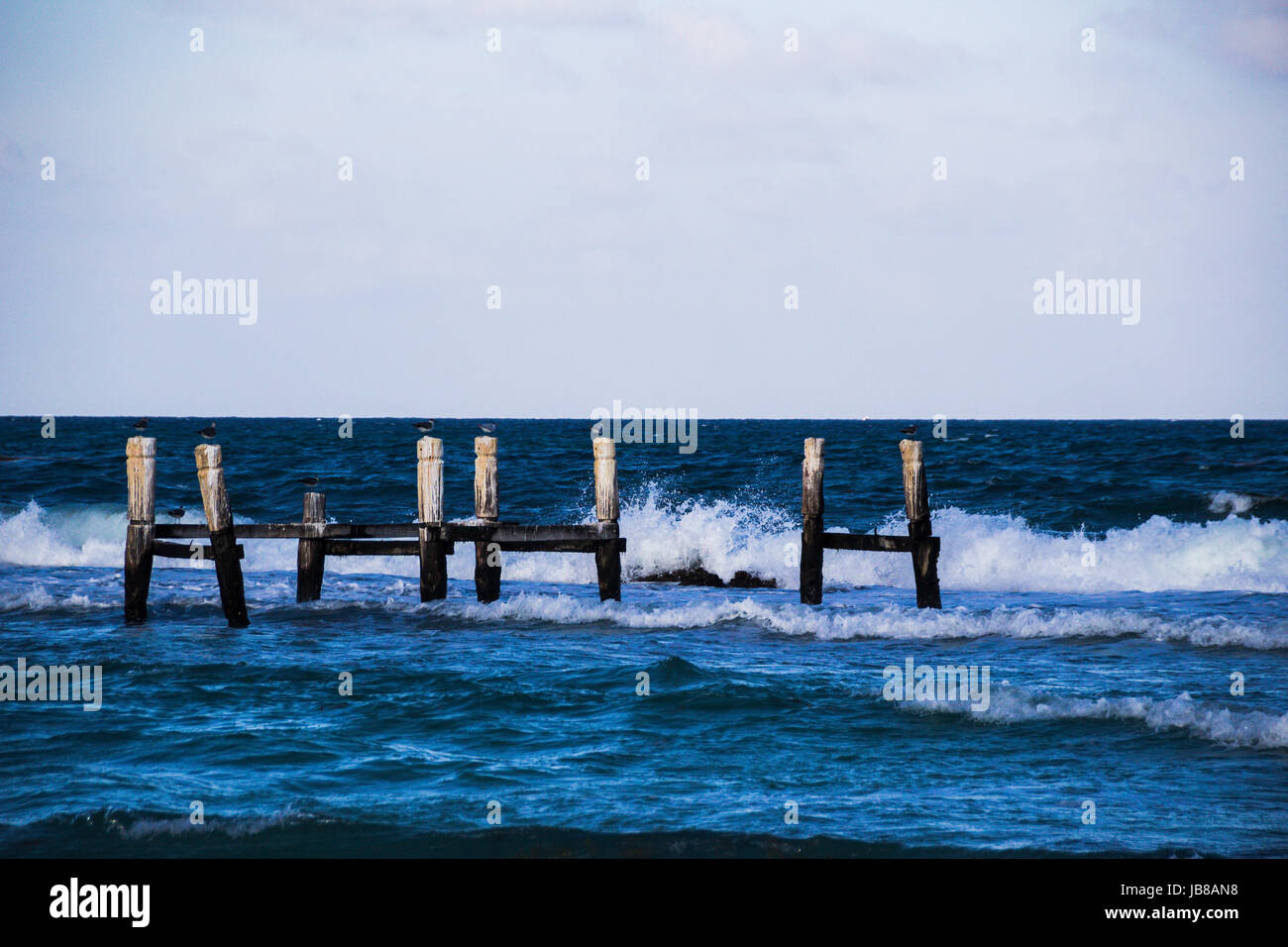 Photograph of an old dock in the ocean Stock Photo - Alamy