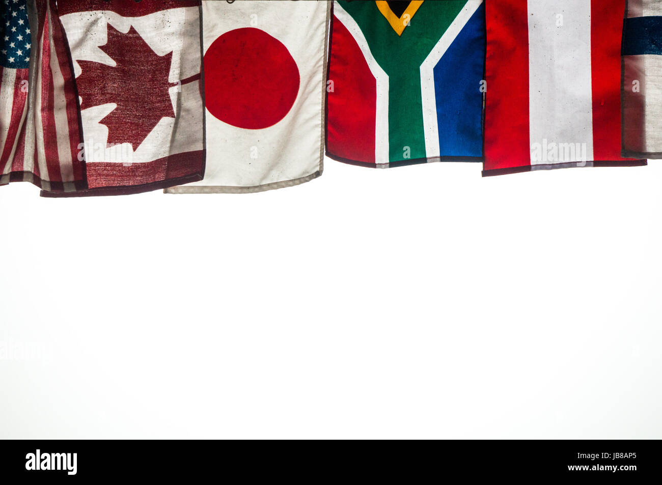 Flags of multiple countries on a string Stock Photo - Alamy