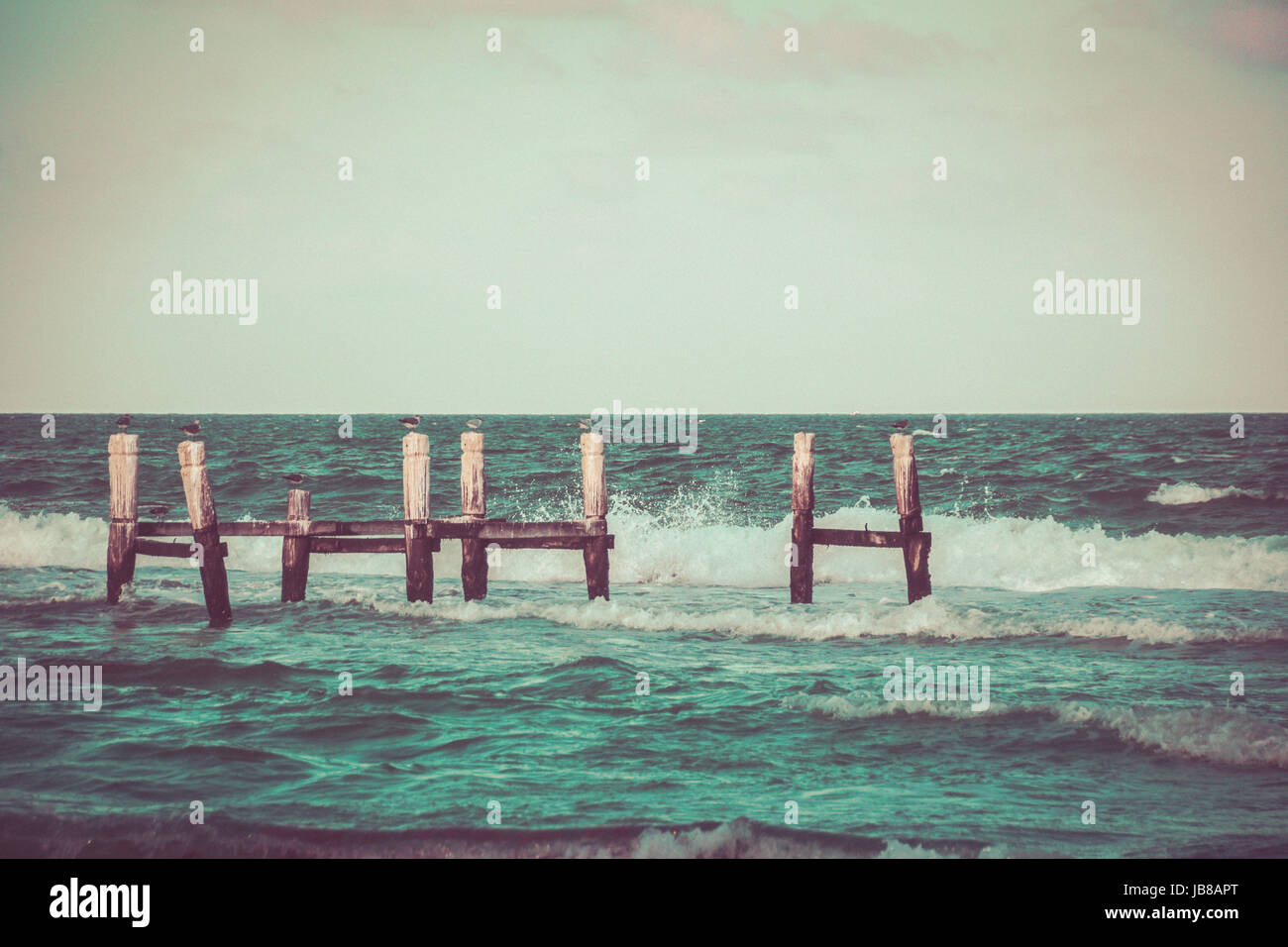 Photograph of an old dock in the ocean Stock Photo - Alamy