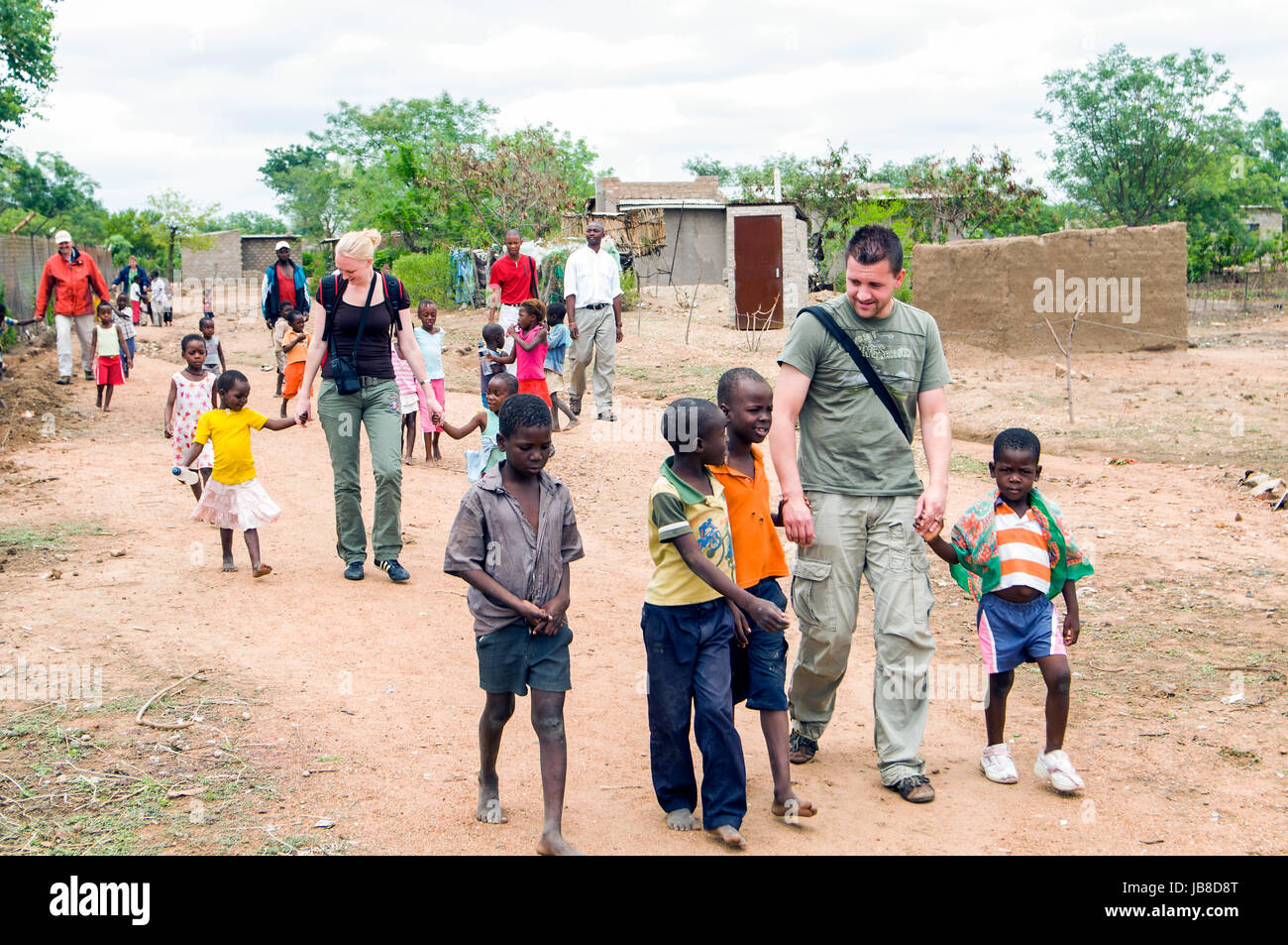 Tourists with native children, Lulekani township, Olifants River, South ...
