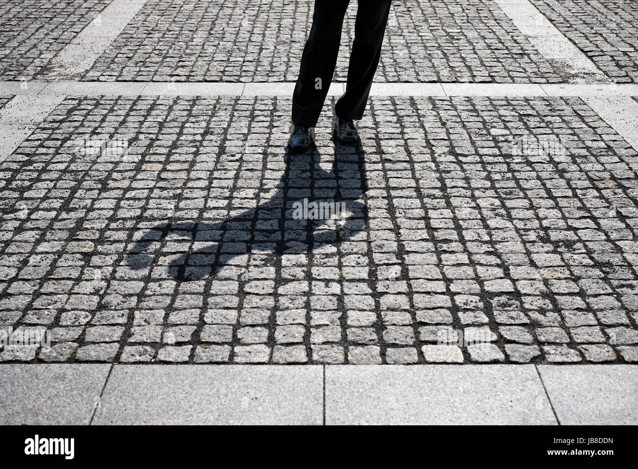 The shadow of a man in the city The concept of a strong man Stock Photo ...