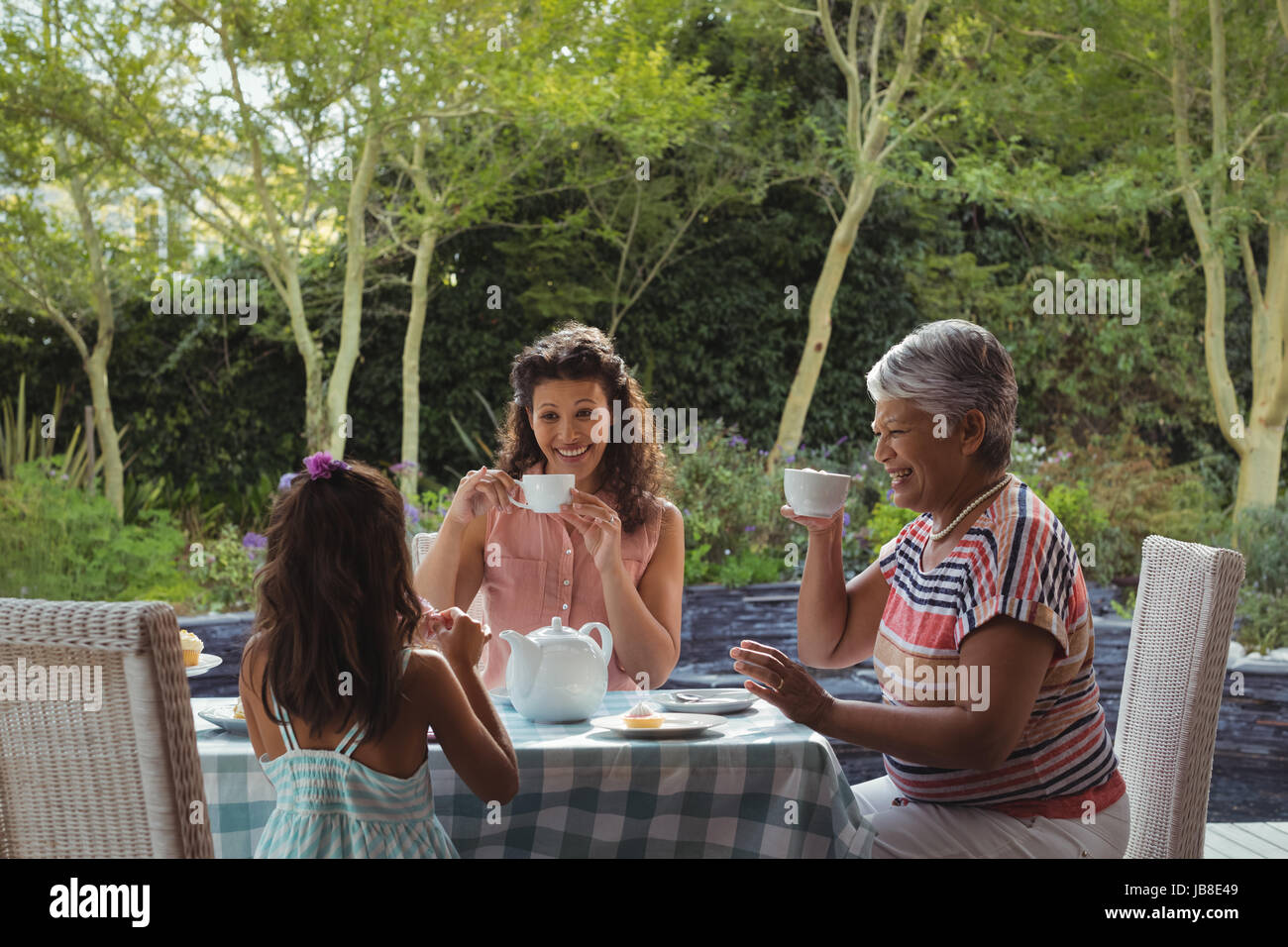 Happy family having tea at home Stock Photo - Alamy