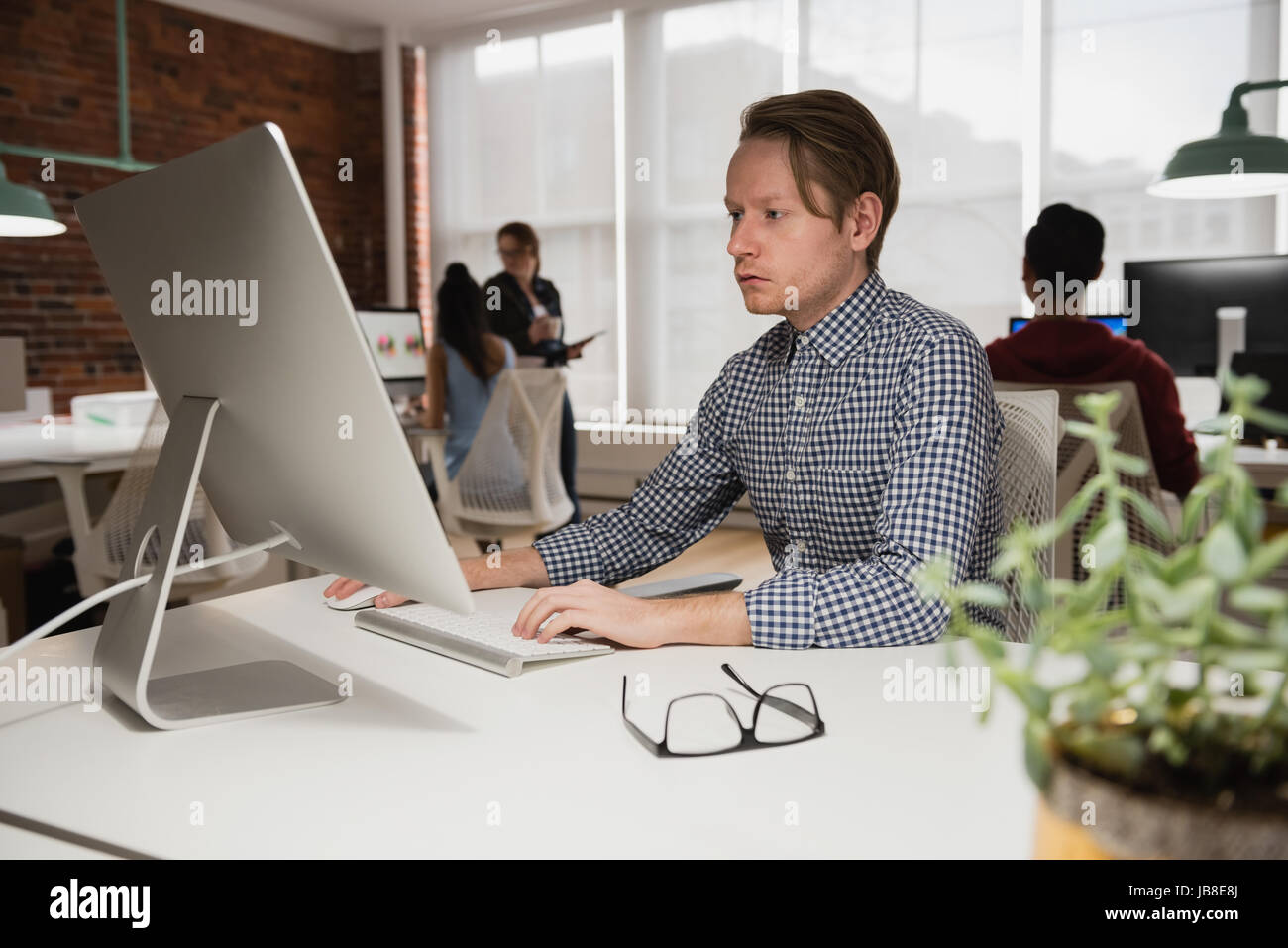 Attentive male executive working on computer in office Stock Photo - Alamy