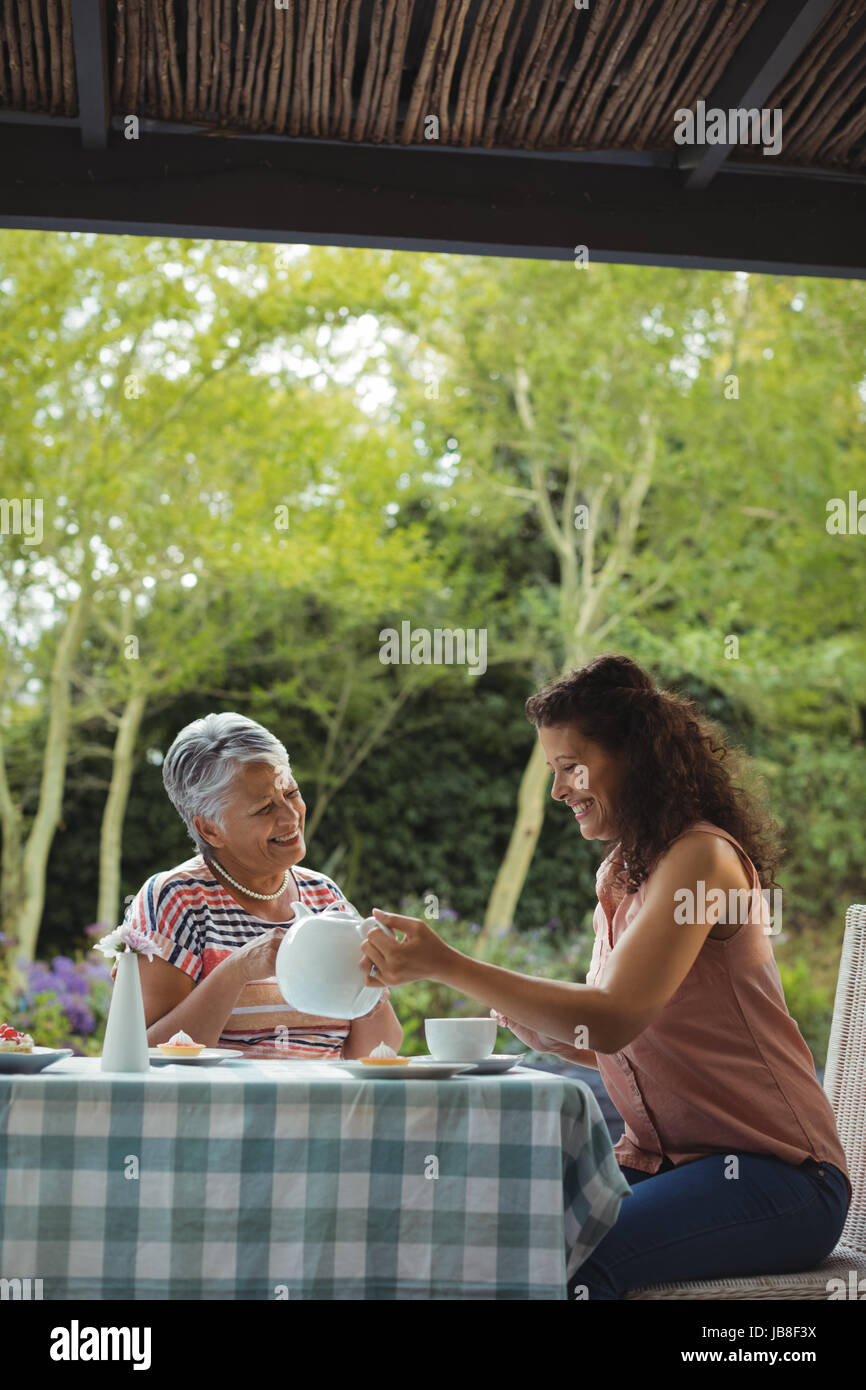 Mother and daughter having tea at home Stock Photo - Alamy