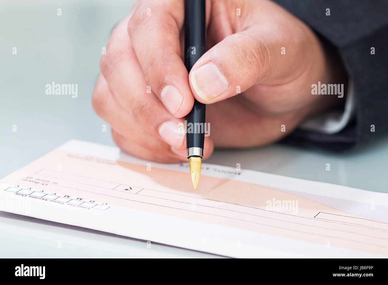 1 Business man Signing Cheque Filling Banking Finance Stock Photo - Alamy
