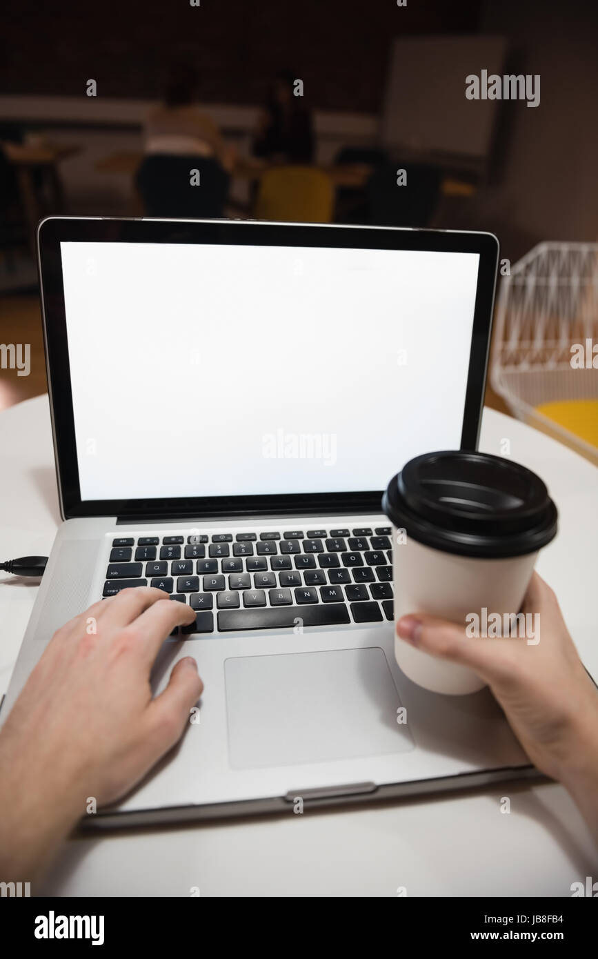 Hand of executive using laptop in office Stock Photo - Alamy