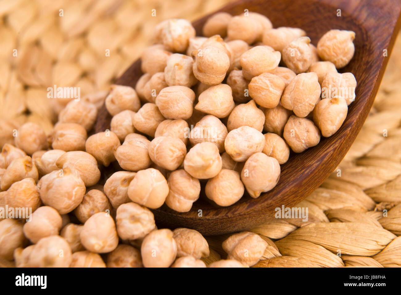 dried white chickpeas ceci on the wooden spoon Stock Photo - Alamy