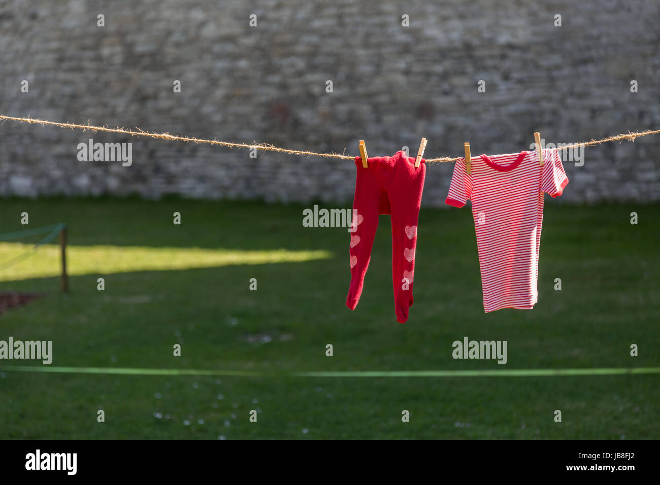 Baby clothes on a rope Stock Photo - Alamy