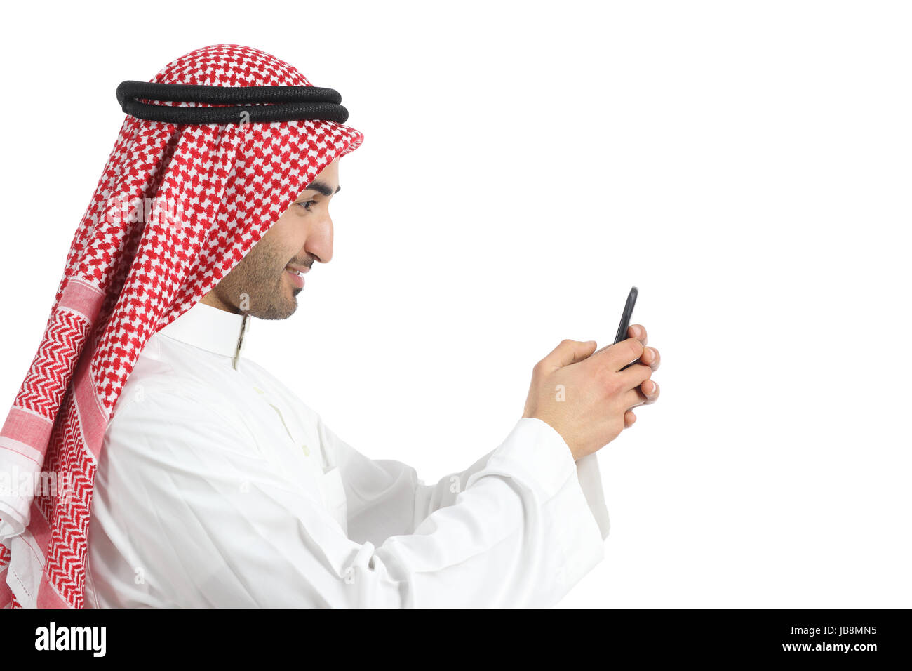 Side view of an arab saudi emirates man using a smart phone isolated on ...