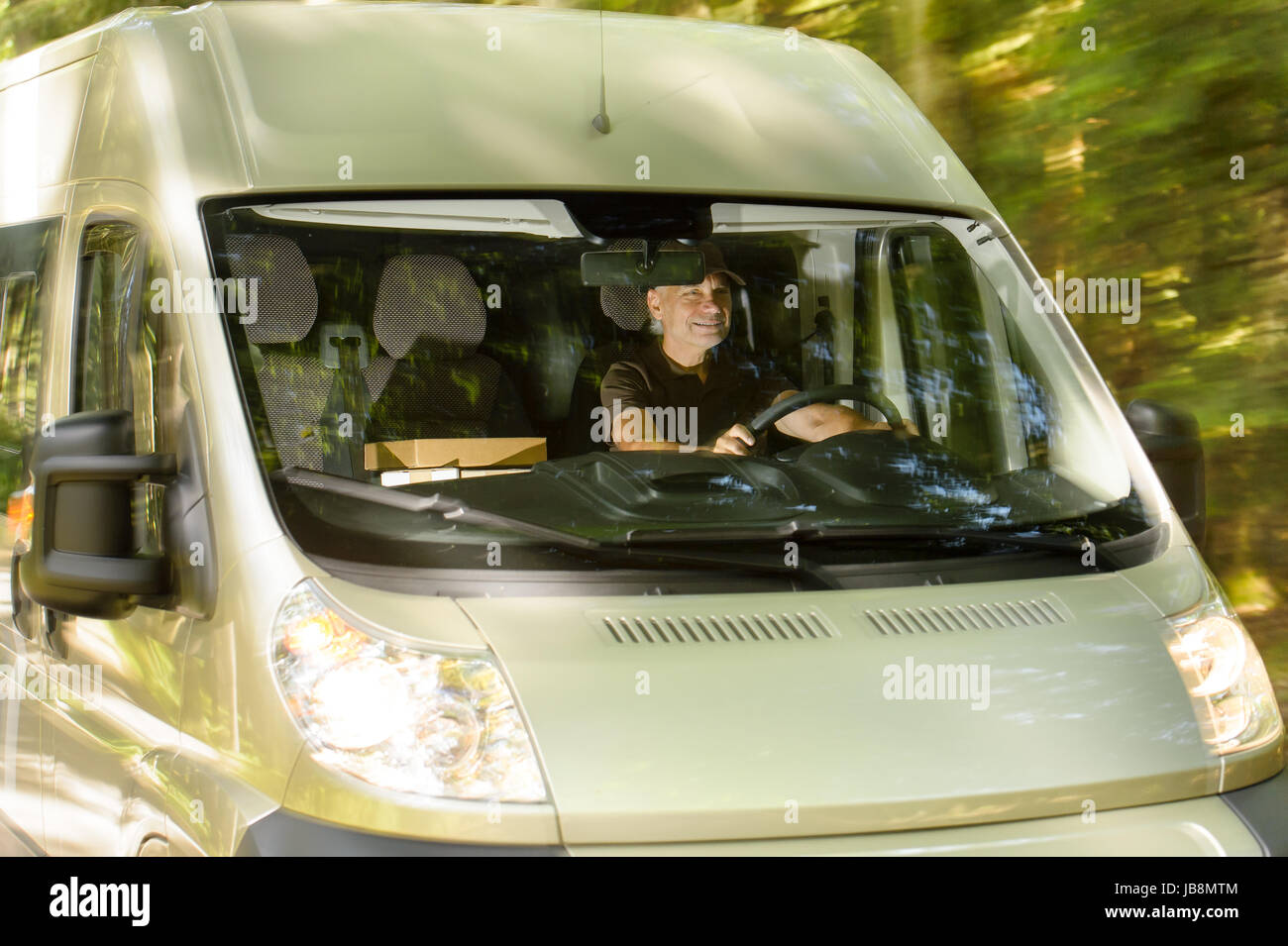 Postal worker driving truck hi-res stock photography and images - Alamy