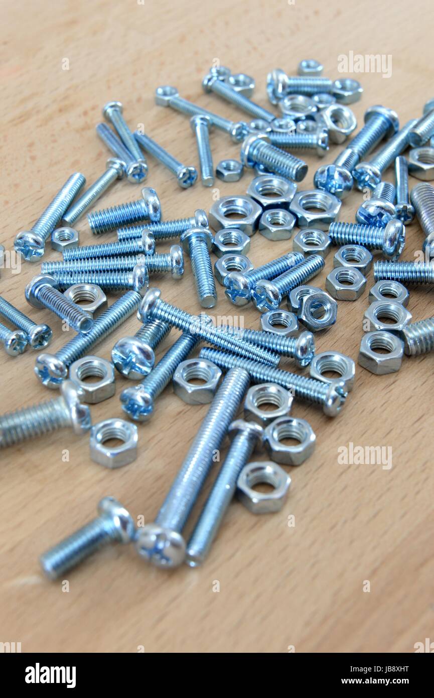Hardware fixings isolated on a wooden bench Stock Photo - Alamy