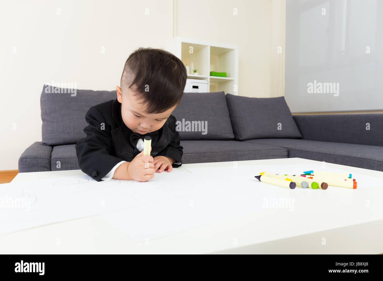 Little boy concentrate on drawing at home Stock Photo - Alamy