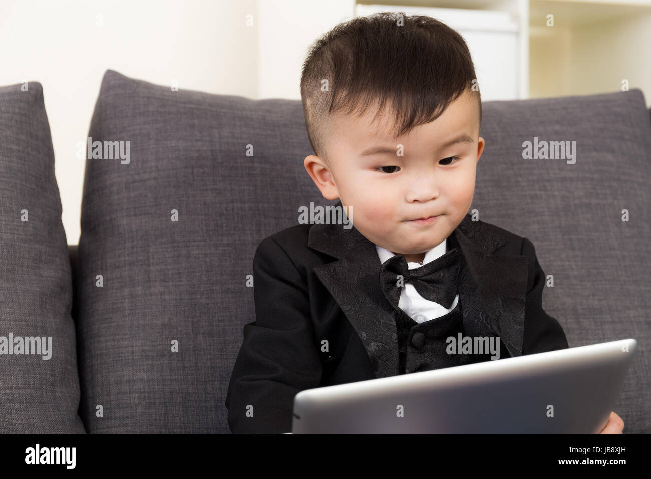 Baby boy using digital tablet Stock Photo - Alamy