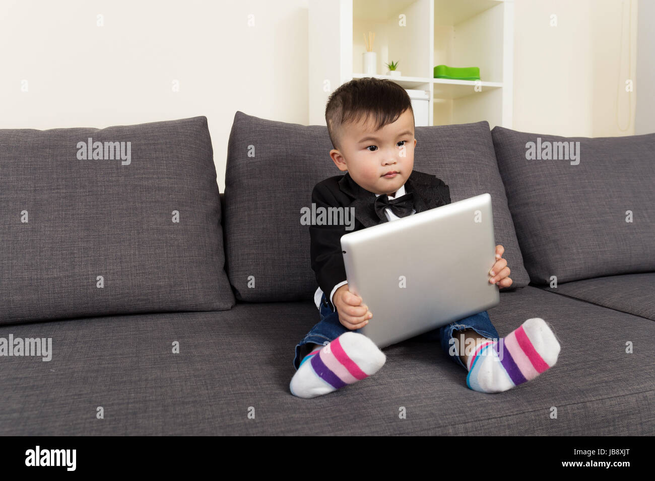 Asian baby boy holding tablet Stock Photo - Alamy