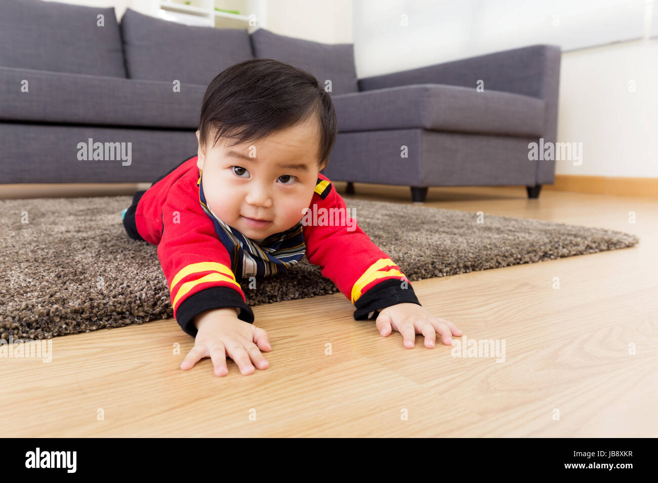 Little boy creeping on floor Stock Photo - Alamy