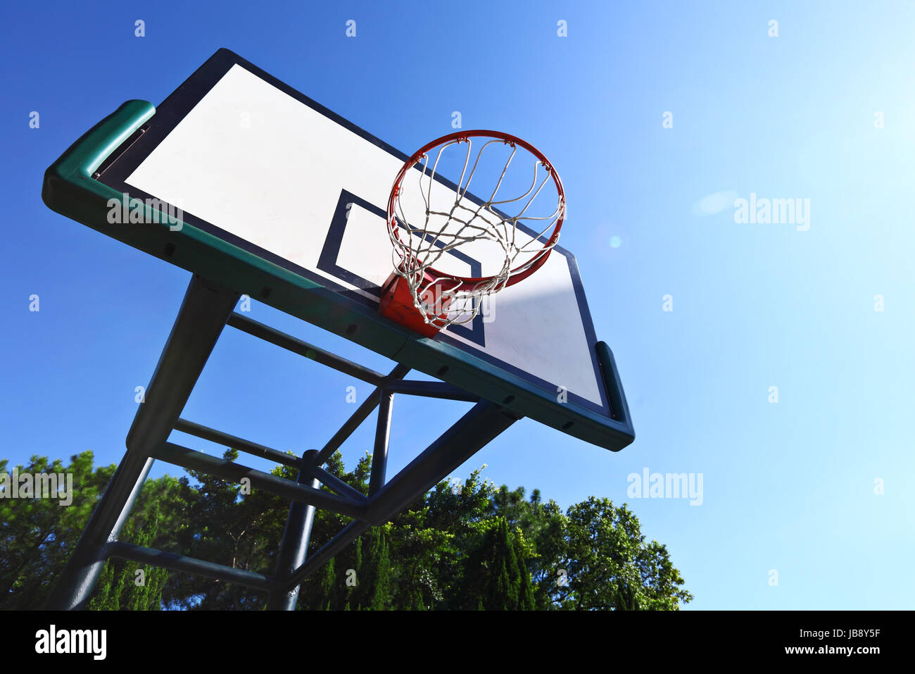 Basketball hoop with clear blue sky Stock Photo - Alamy