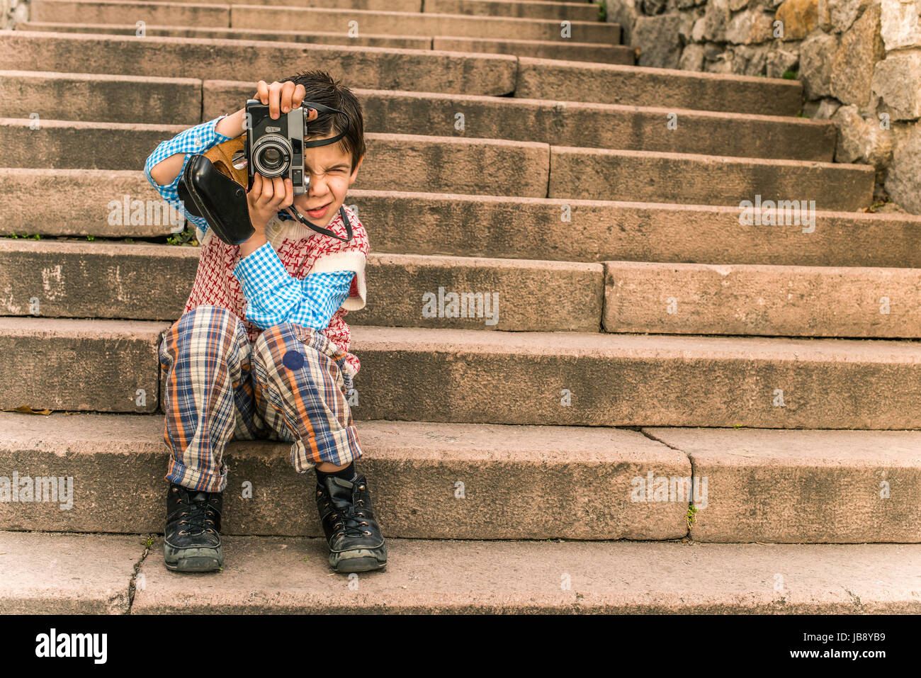 Child with vintage camera. Exterior stairs Stock Photo - Alamy