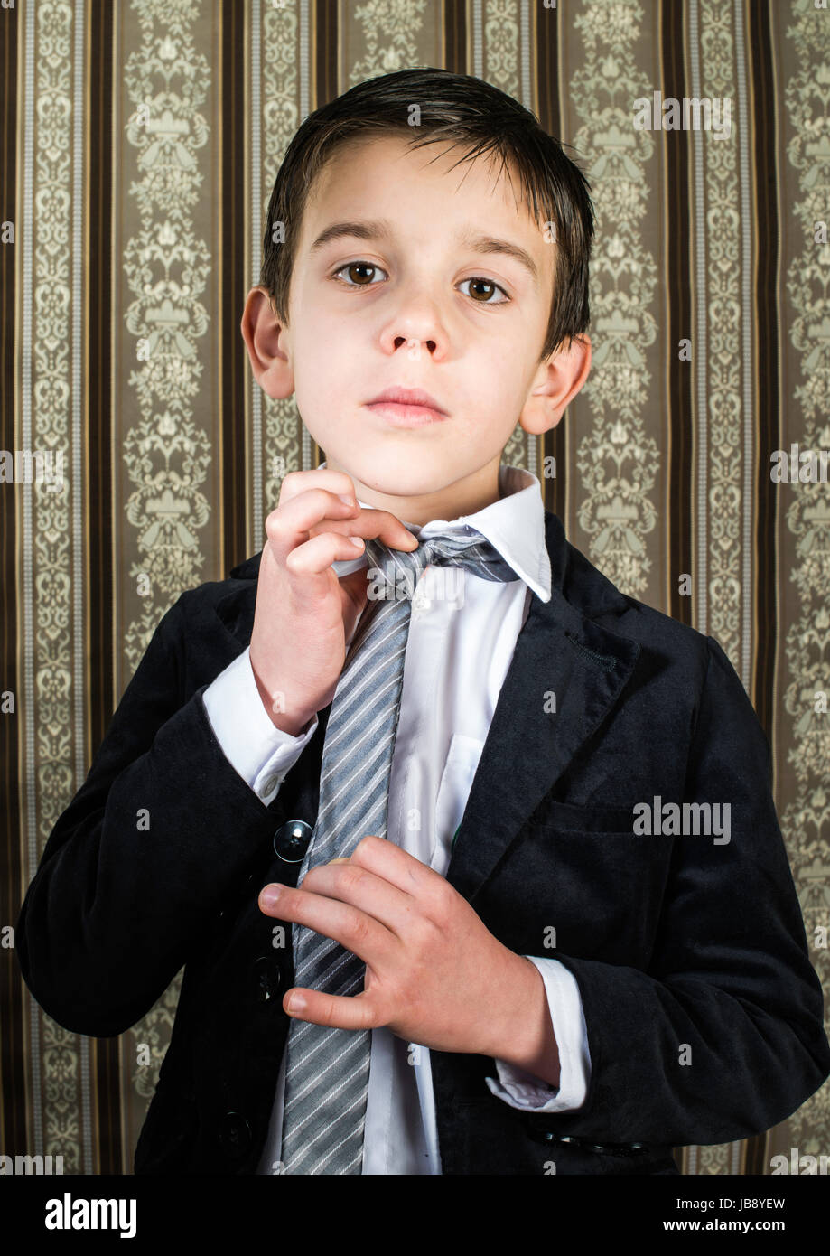 Boy in vintage black suit and tie Stock Photo - Alamy