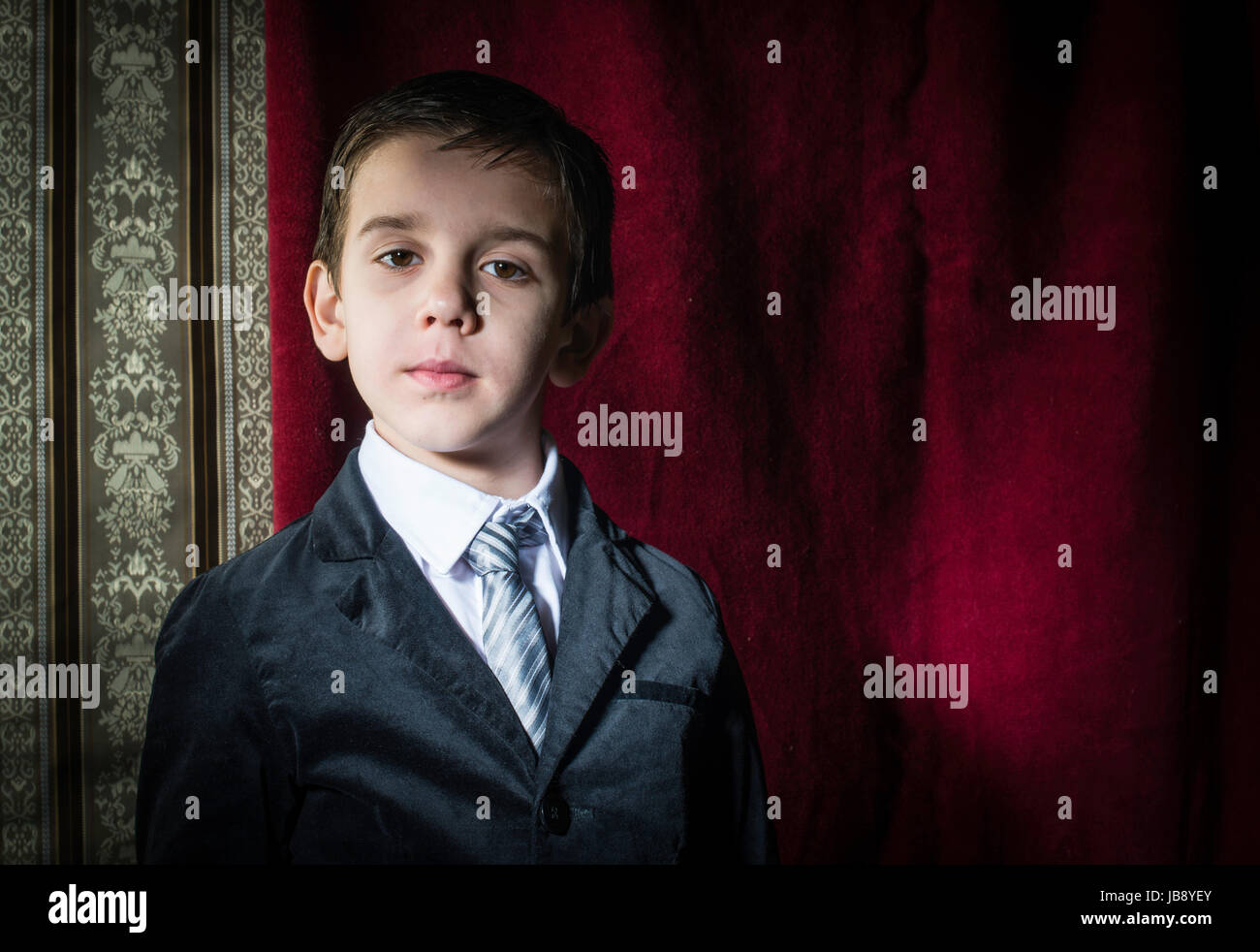 Boy in vintage black suit and tie Stock Photo - Alamy