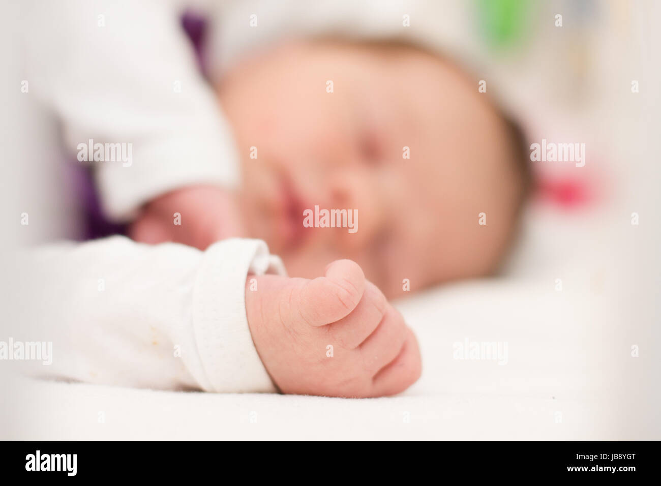 Newborn baby sleeping hand in focus Stock Photo - Alamy