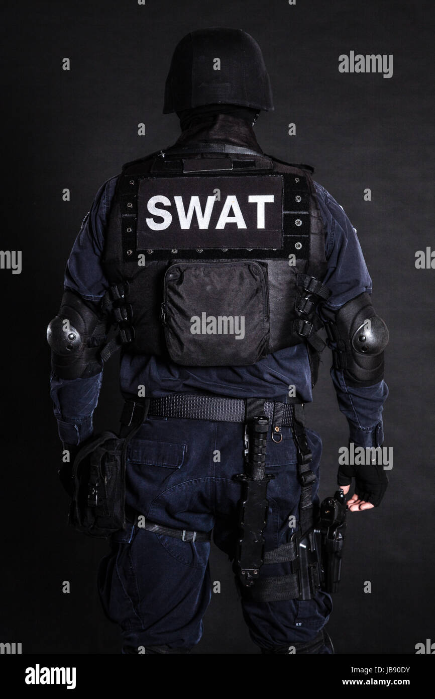 Special weapons and tactics (SWAT) team officer on black background ...