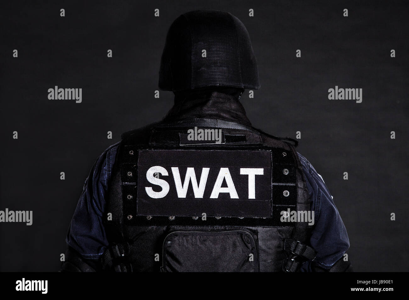 Special weapons and tactics (SWAT) team officer on black background ...