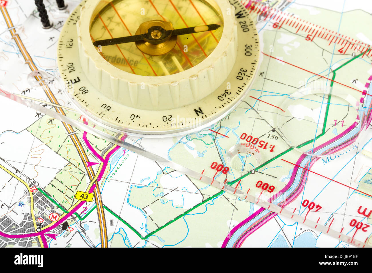old touristic handheld compass on detailed territory map Stock Photo ...