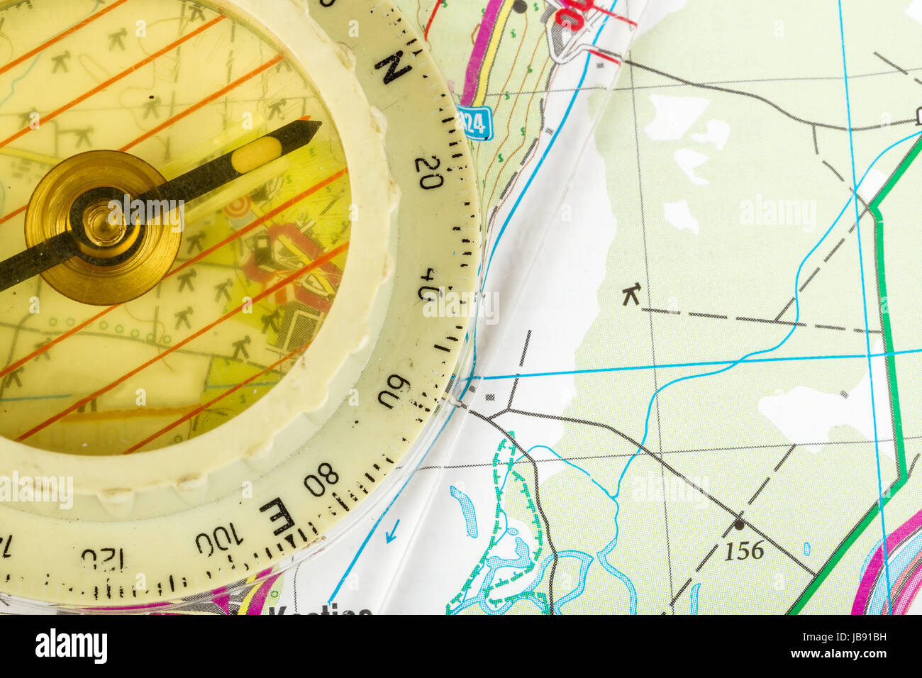 old touristic handheld compass on detailed territory map Stock Photo ...