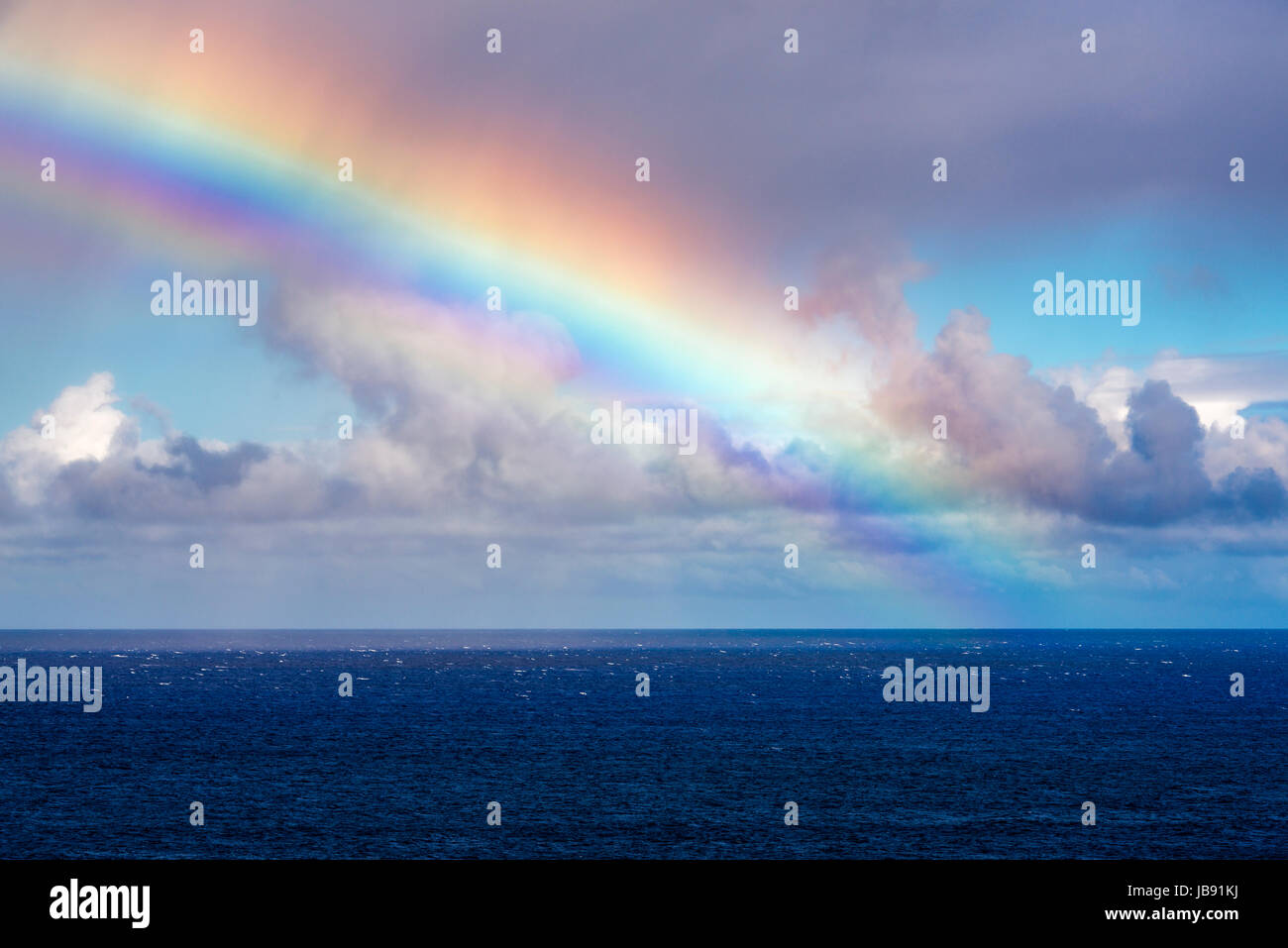 Rainbow and squall over the Pacific Ocean, Hanalei, Kauai, Hawaii USA ...
