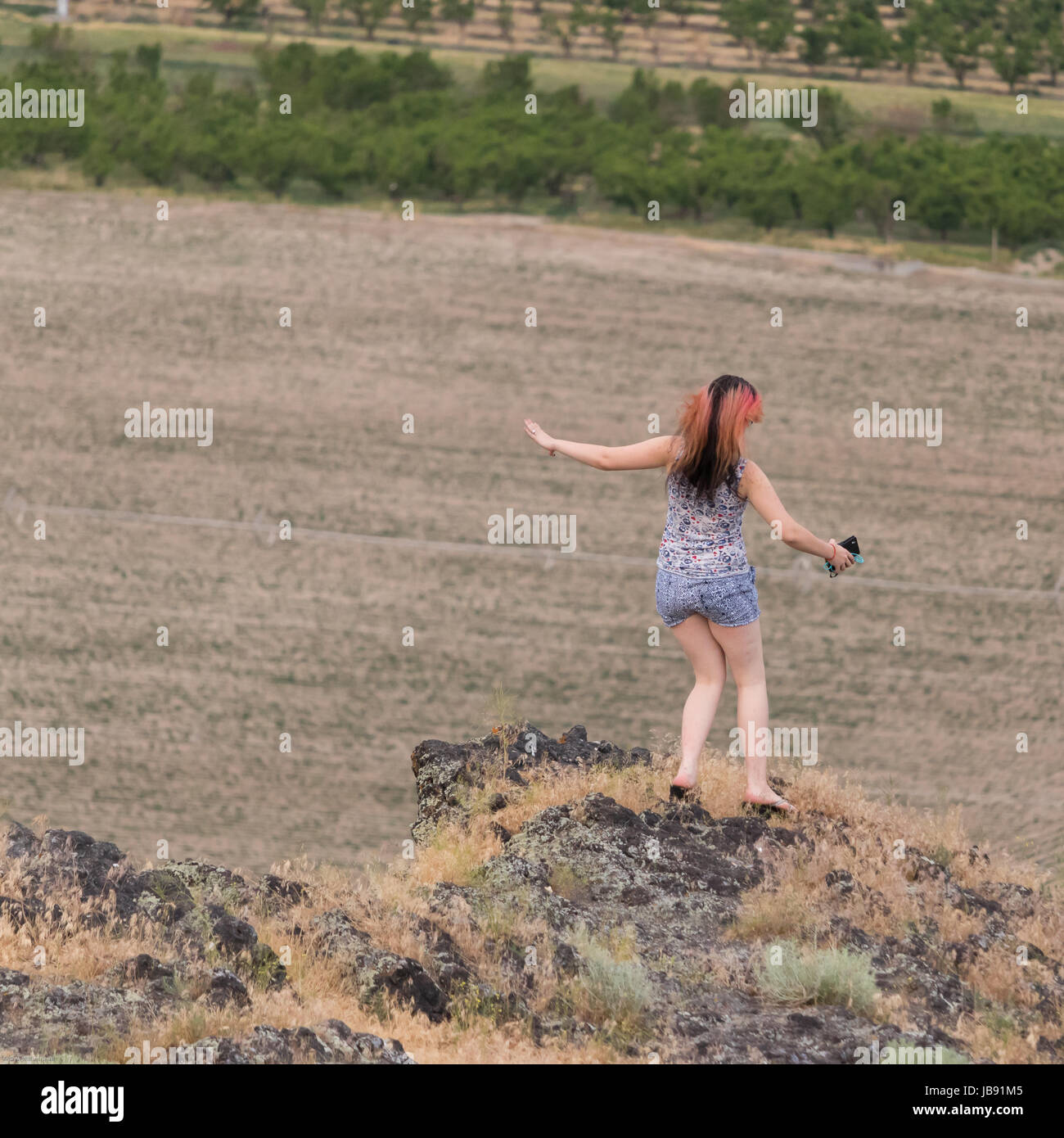 Young lady climbing Lizard Butte (taken from above Stock Photo - Alamy