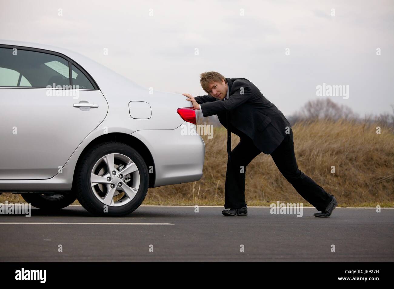 Pushing a broken down car Stock Photo - Alamy