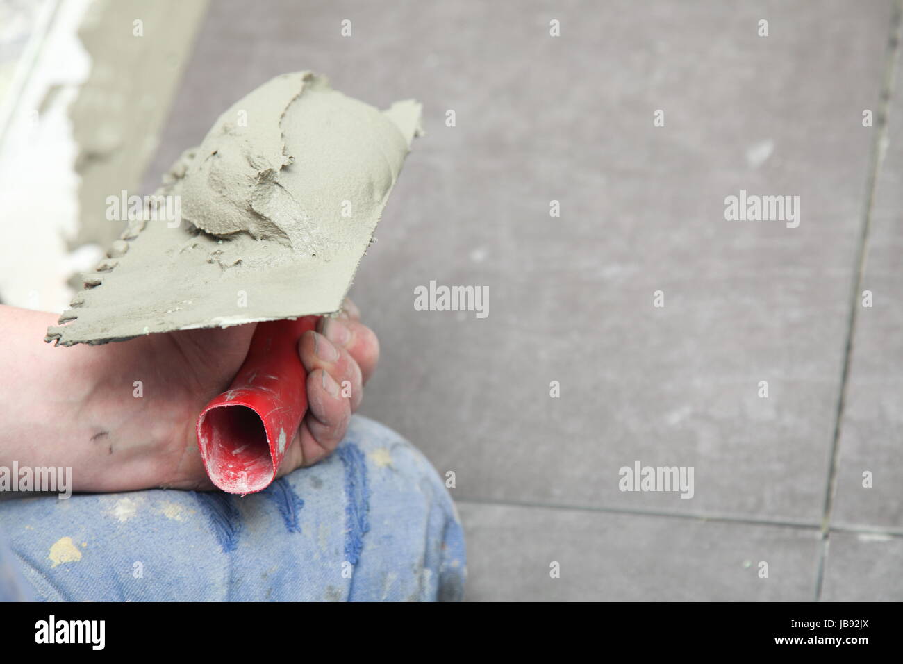 Man Construction worker is tiling at home, tile floor adhesive Stock ...