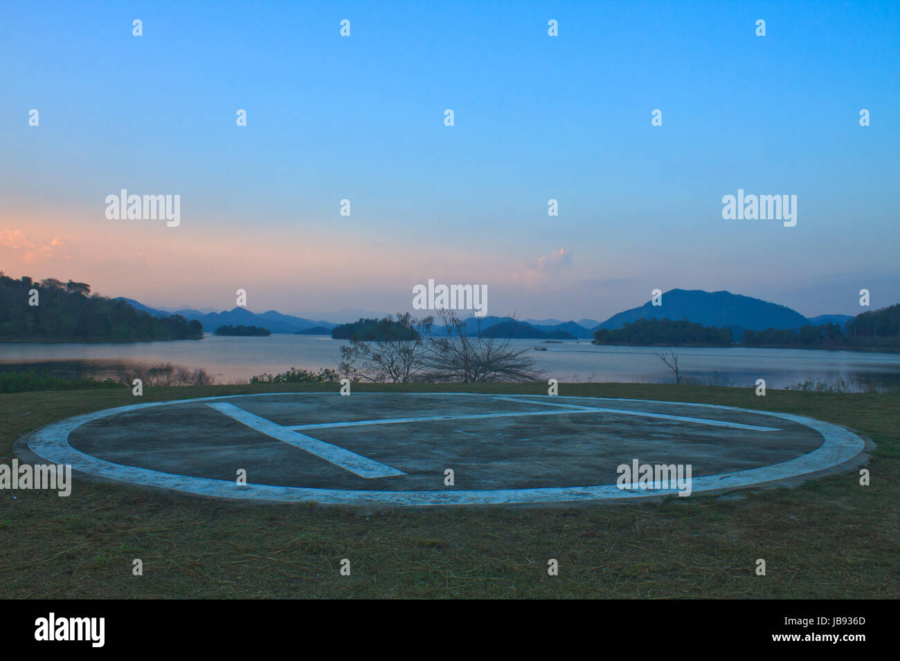 Helipad area for helicopter parking near lake on sunset Stock Photo - Alamy