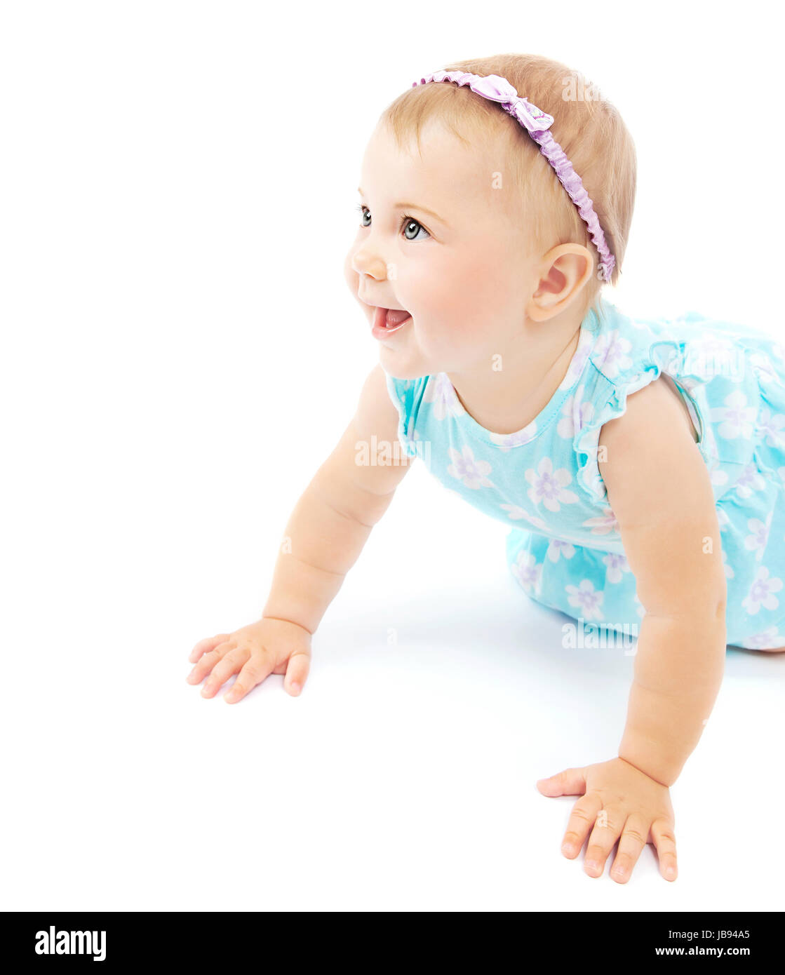 Adorable little baby girl laughing, crawling and playing at studio ...