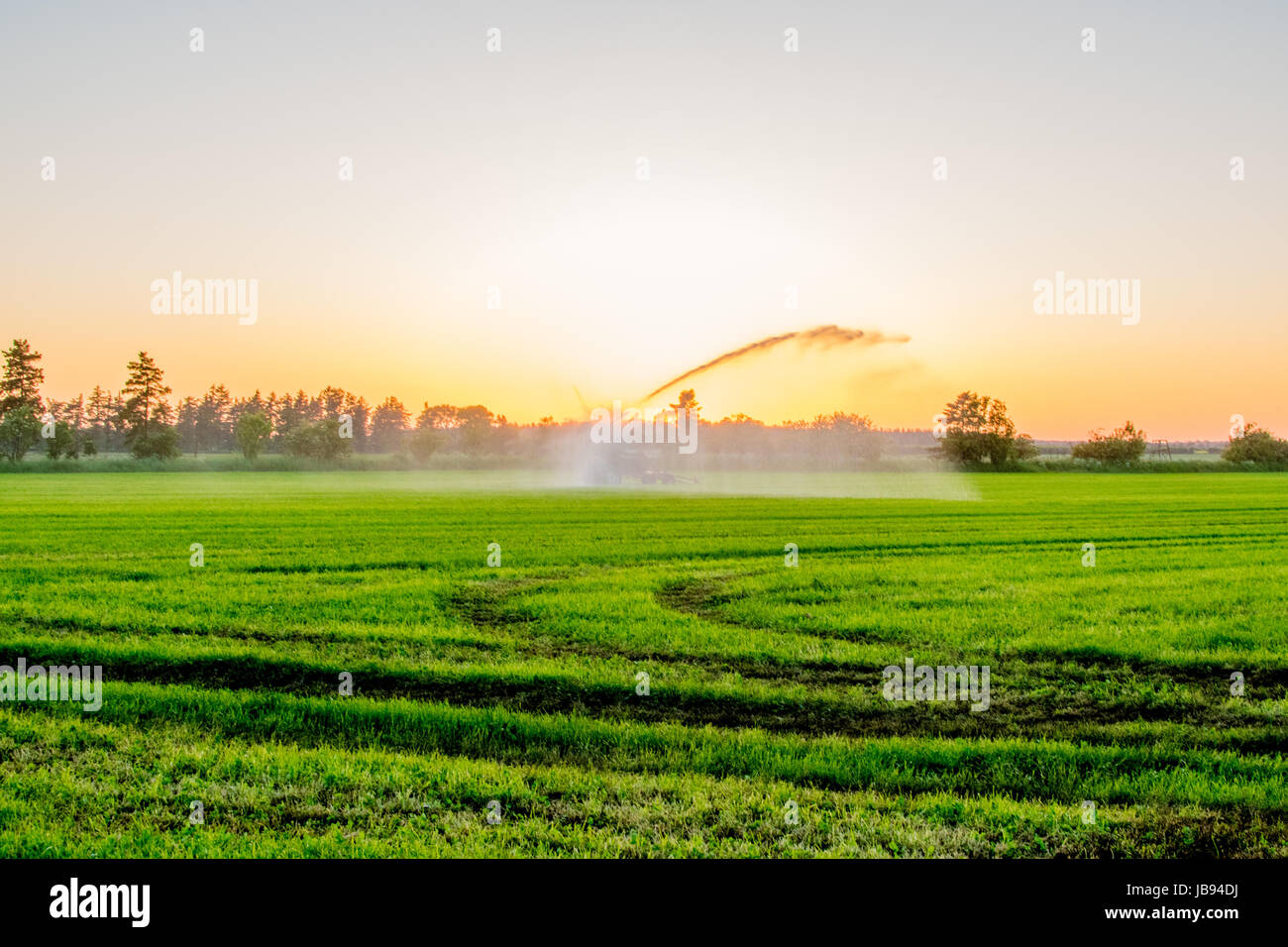 water pump at sunset in a big green field Europe Stock Photo - Alamy