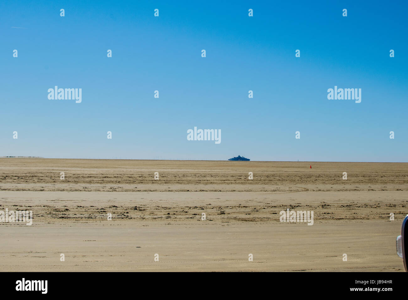 very big sand space with a blue background sky Stock Photo - Alamy