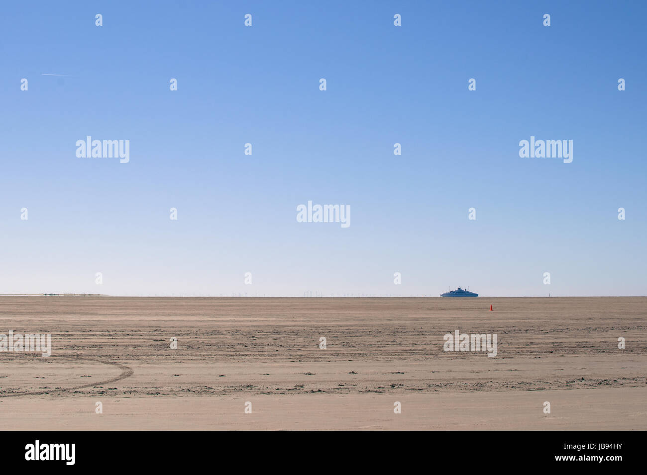 very big sand space with a blue background sky Stock Photo - Alamy