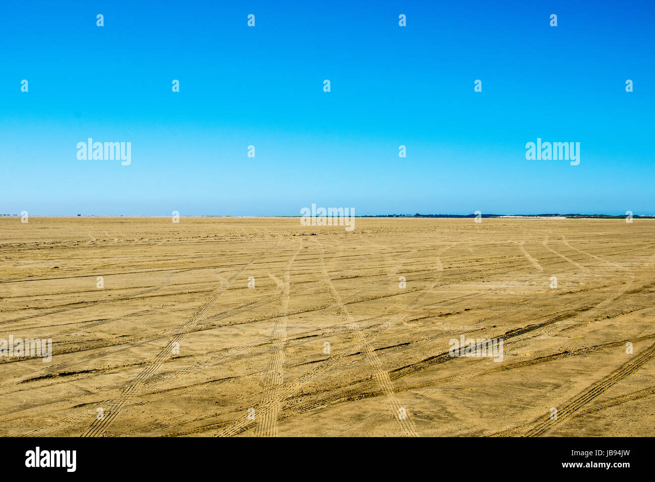 very big sand space with a blue background sky Stock Photo - Alamy