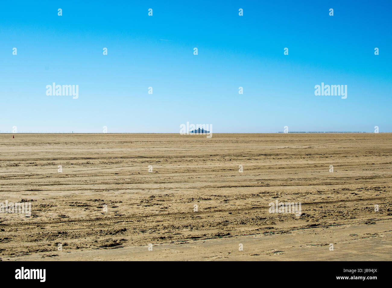 very big sand space with a blue background sky Stock Photo - Alamy