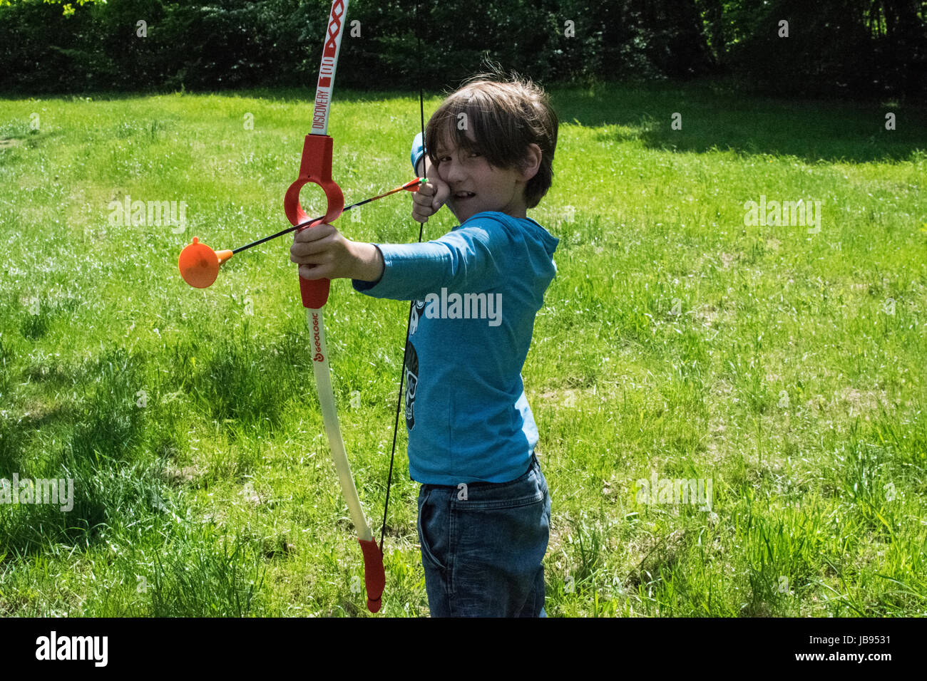 blond european boy with a bow in nature Stock Photo - Alamy