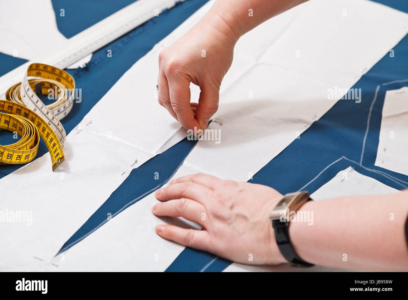drawing of pattern for cutting clothes from blue fabric Stock Photo - Alamy