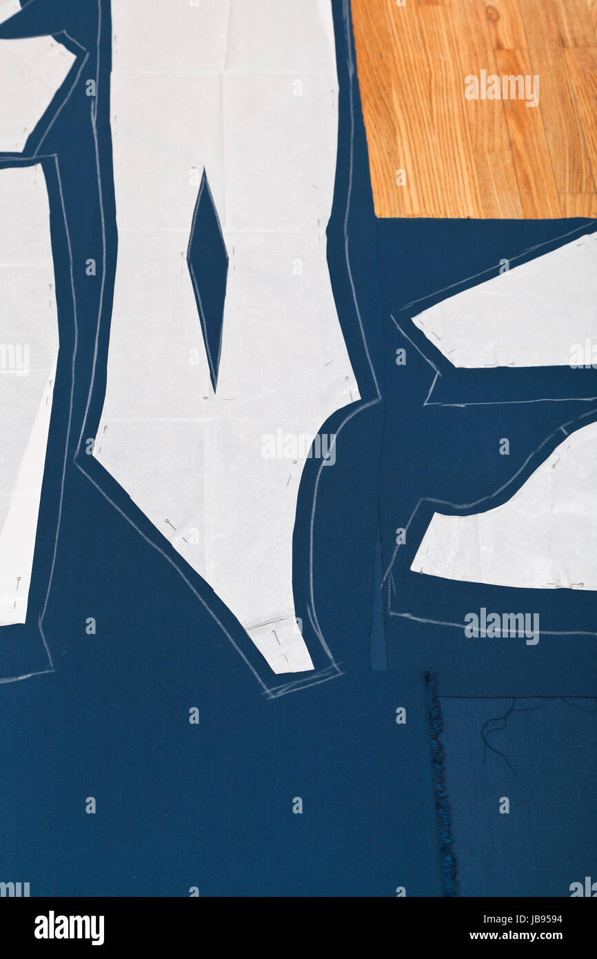 cutting pattern and paper model of dress on blue fabric Stock Photo - Alamy