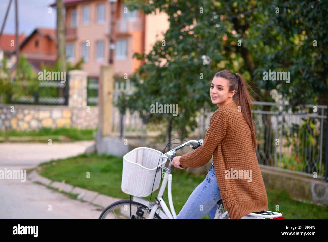 beautiful smiling girl with a bicycle on the road Stock Photo - Alamy