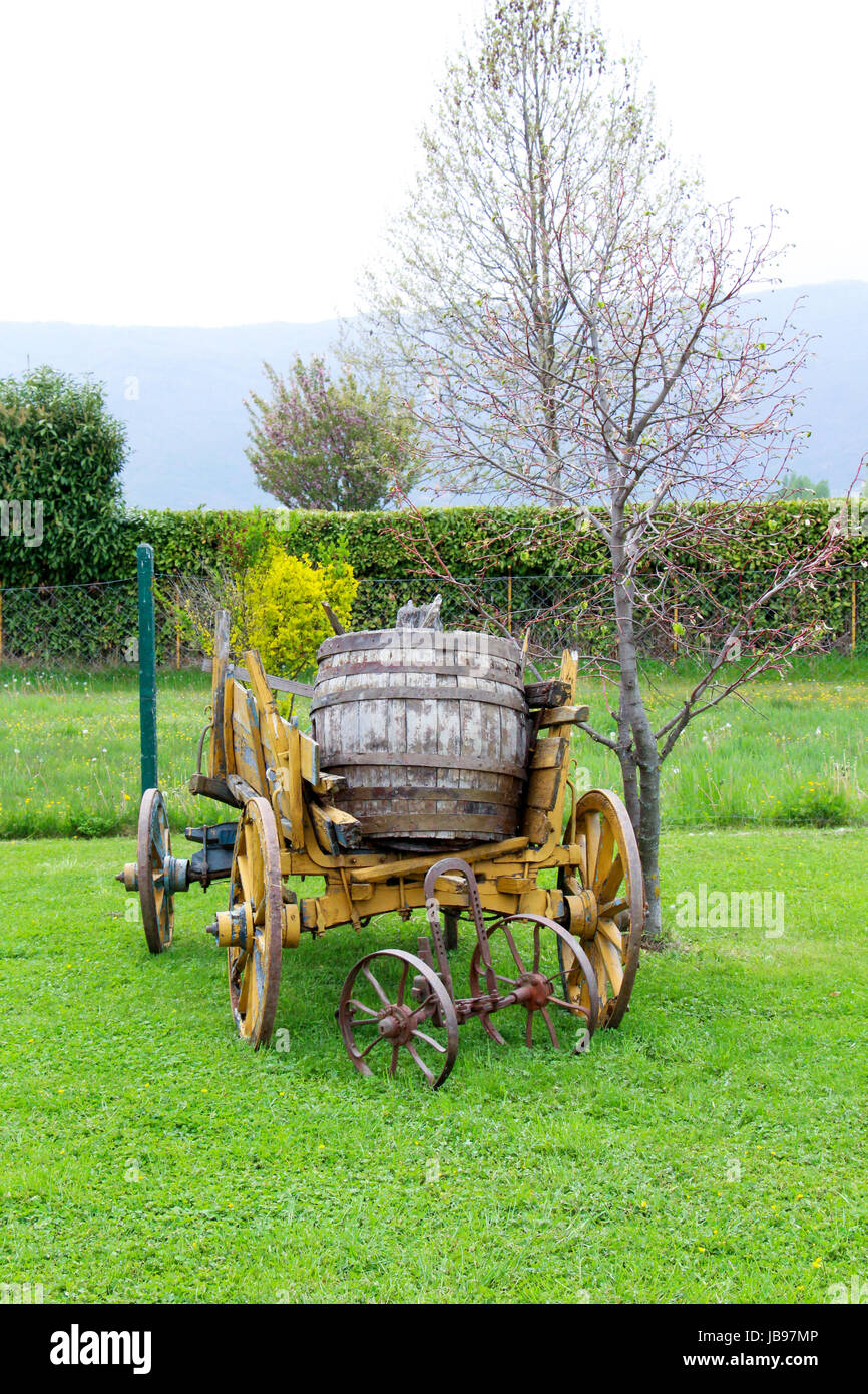 yellow wooden wagon with painted wheels.image of a Stock Photo - Alamy