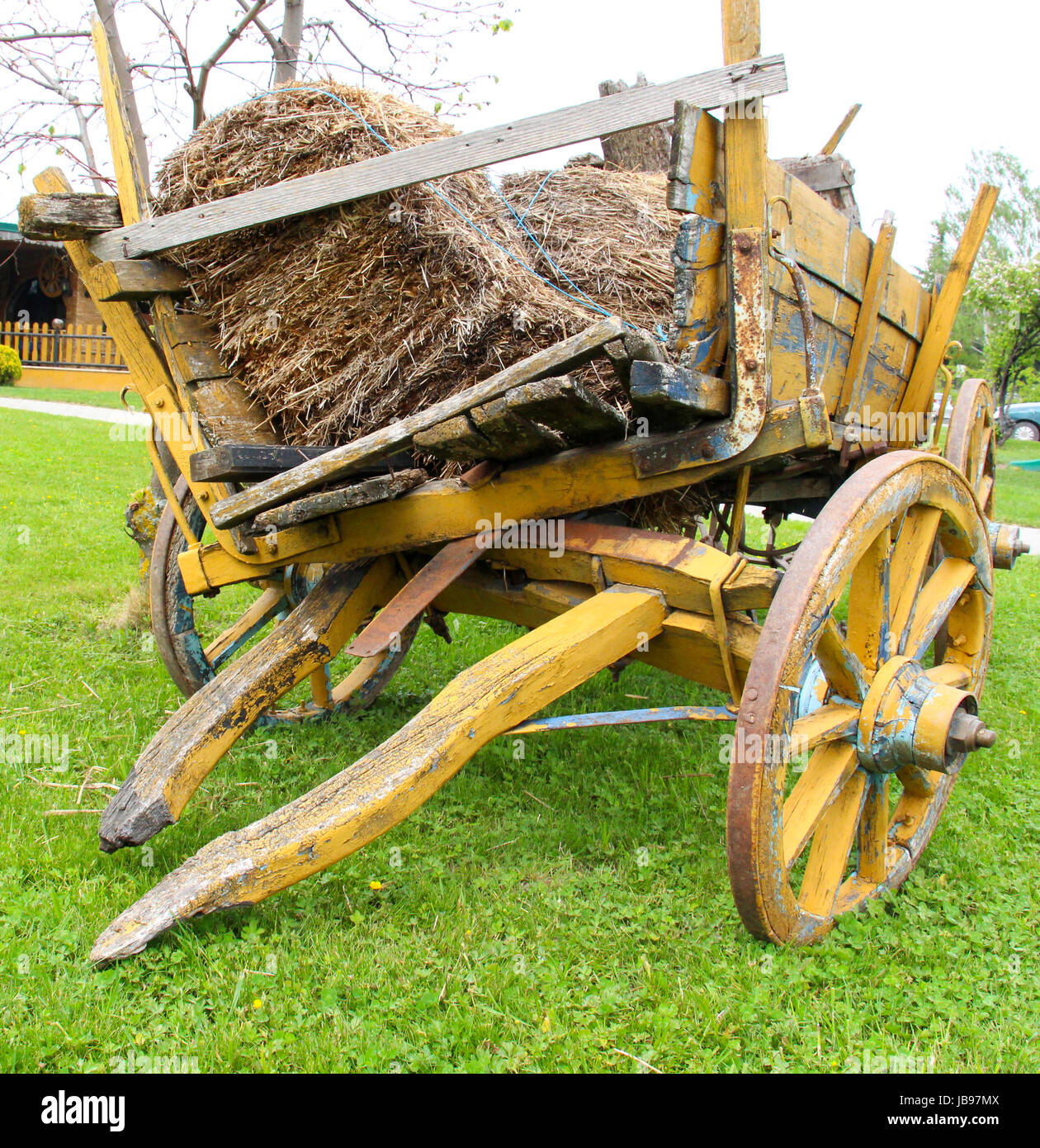 yellow wooden wagon with painted wheels.image of a Stock Photo - Alamy