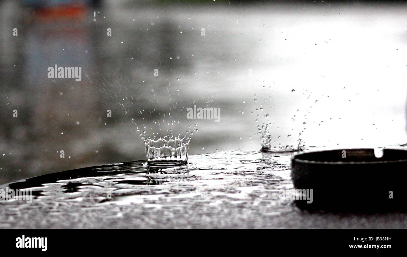 image of a raindrops falling on a table surface Stock Photo - Alamy