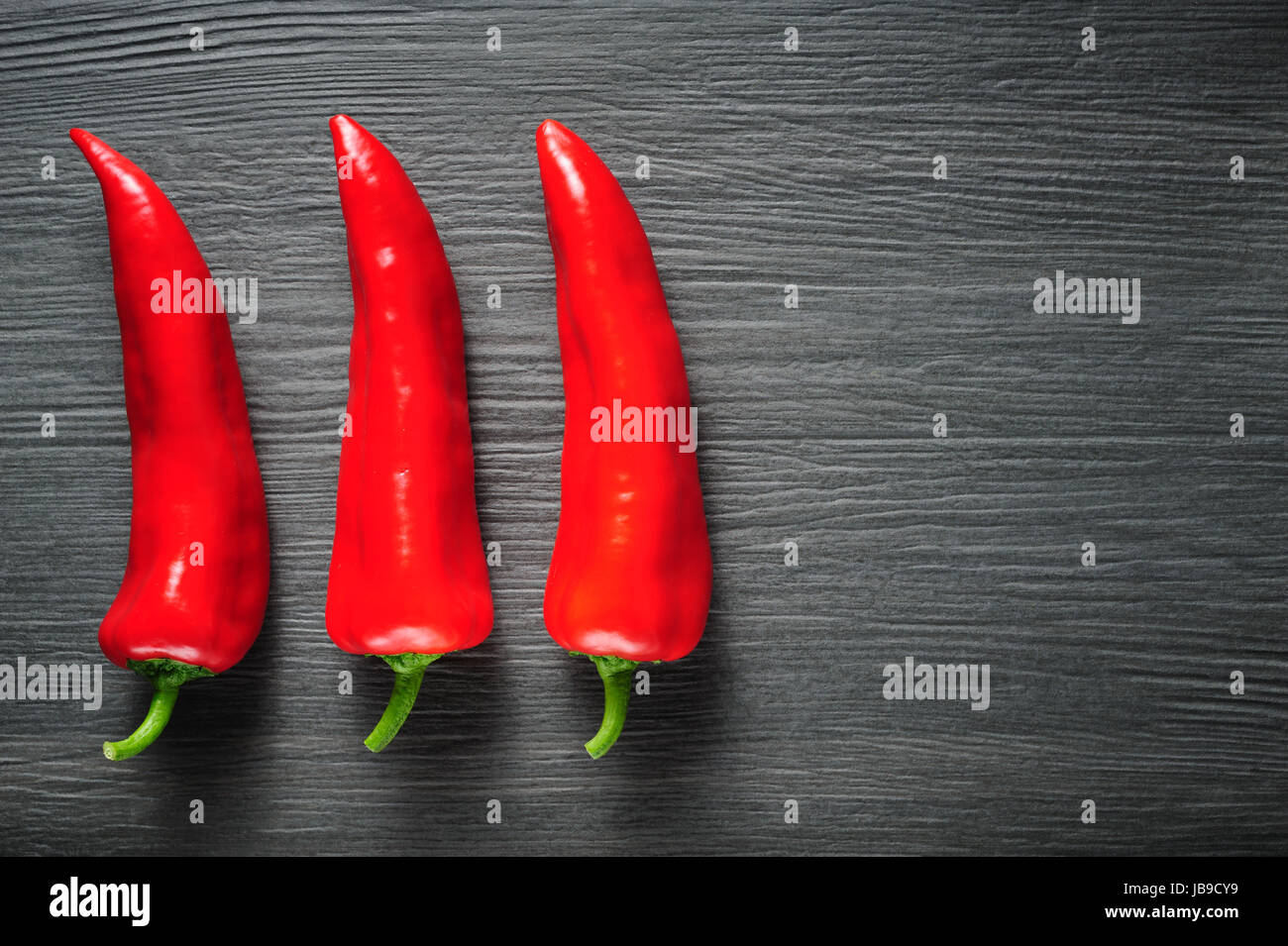 Sweet red Kapia peppers on a dark shale stone background Stock Photo ...